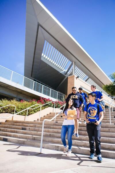 students walking down stairs photo | First Generation